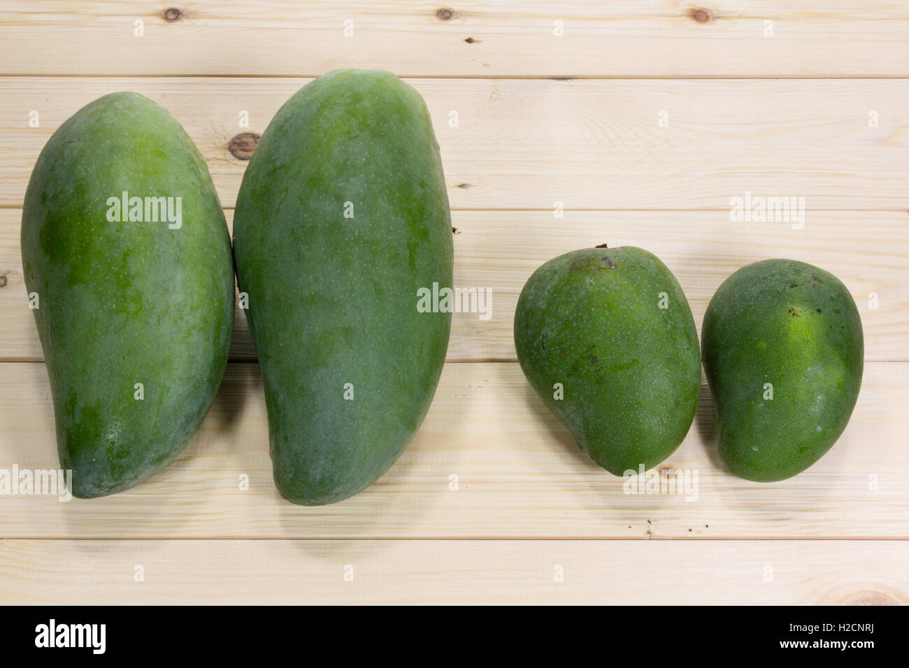 Big green mango on wood background Stock Photo - Alamy