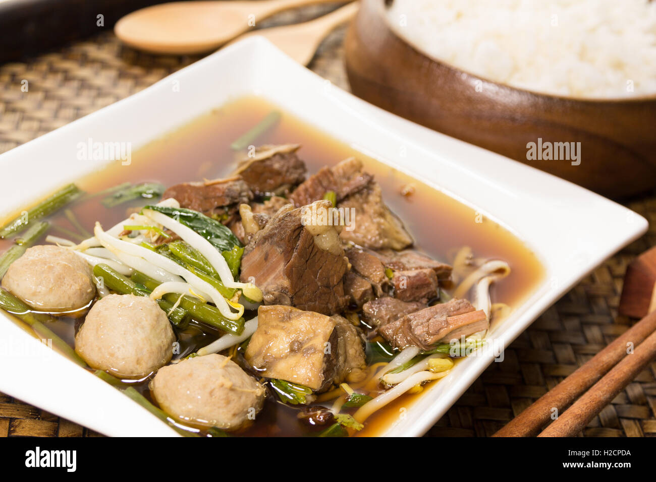 Stewed beef soup with rice on wood tray Stock Photo - Alamy