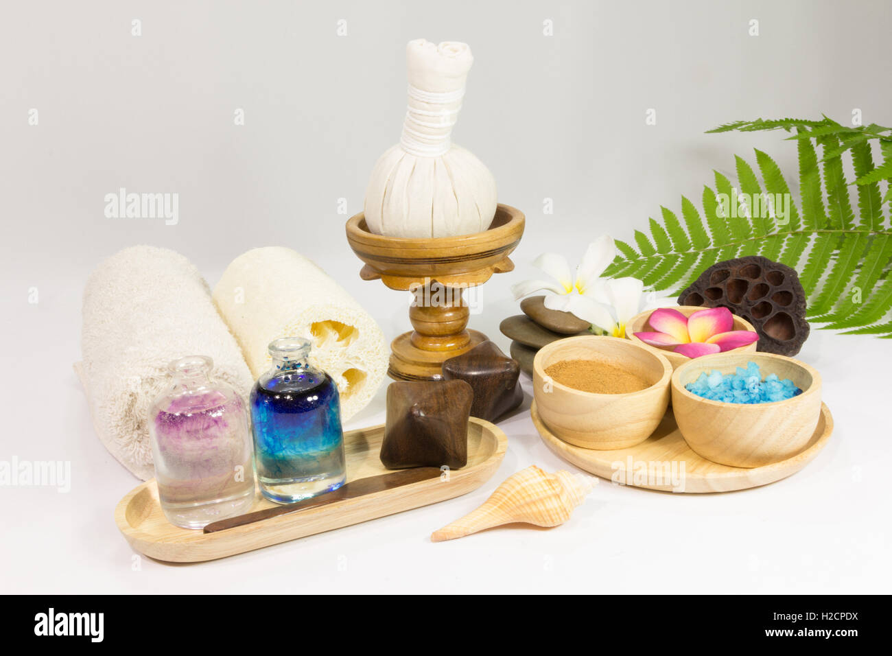 Spa massage setting with towels compress balls and herb Stock Photo - Alamy