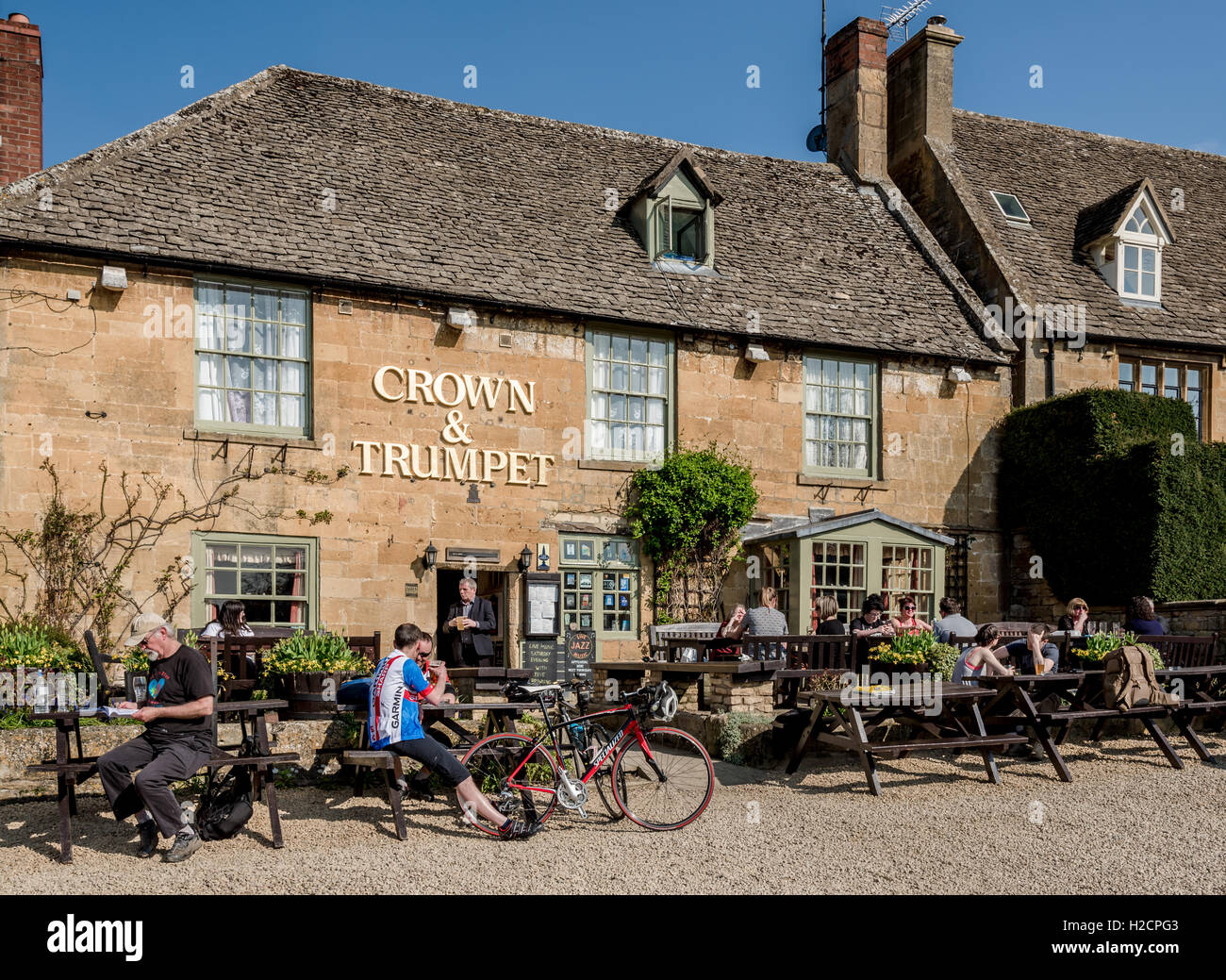 People enjoying an early evening drink in the sunshine in front of a ...