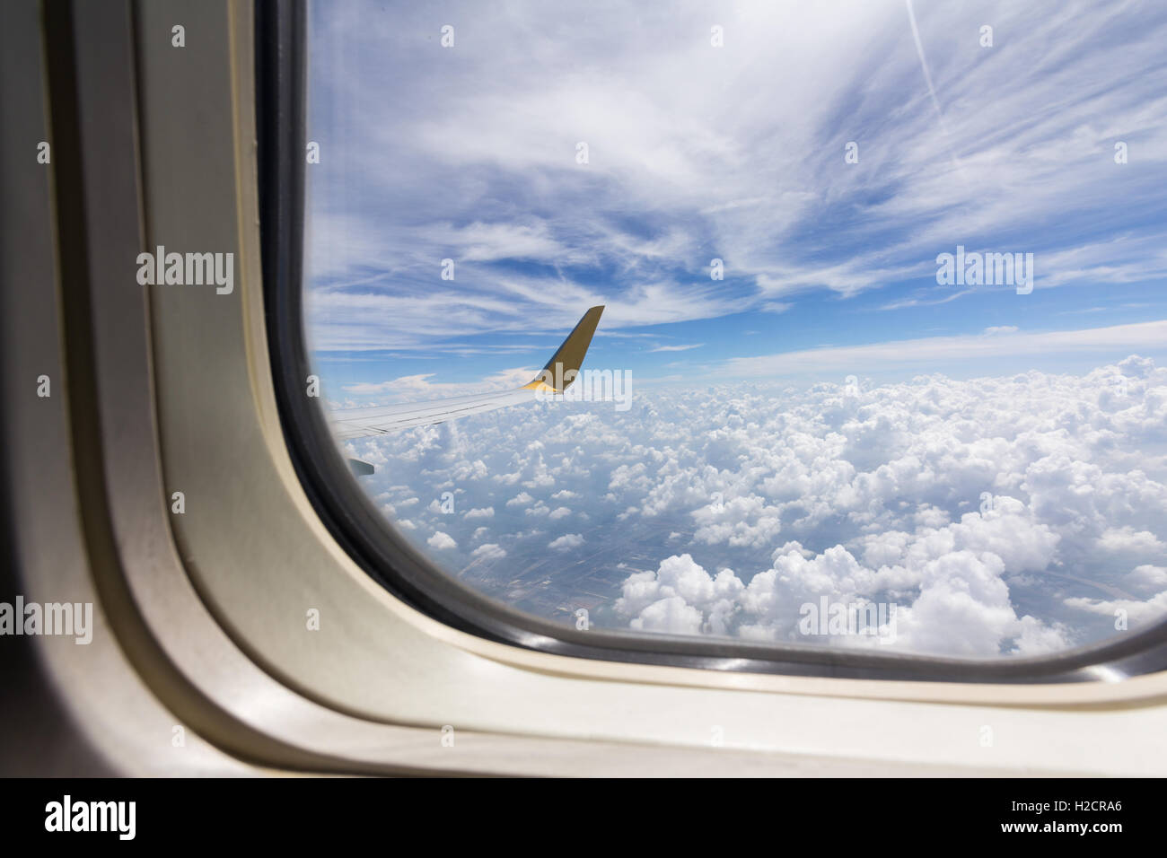 Wing of an airplane flying in the sky Stock Photo - Alamy