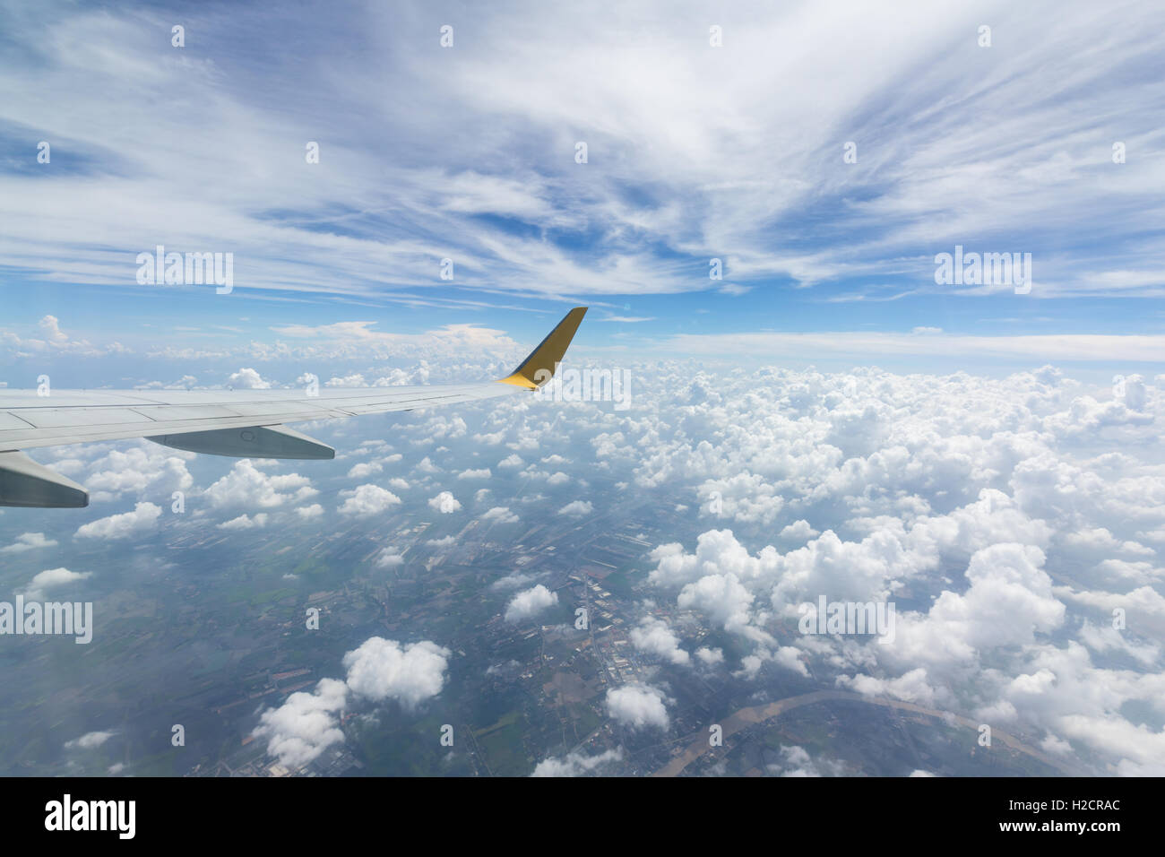 Wing of an airplane flying in the sky Stock Photo - Alamy