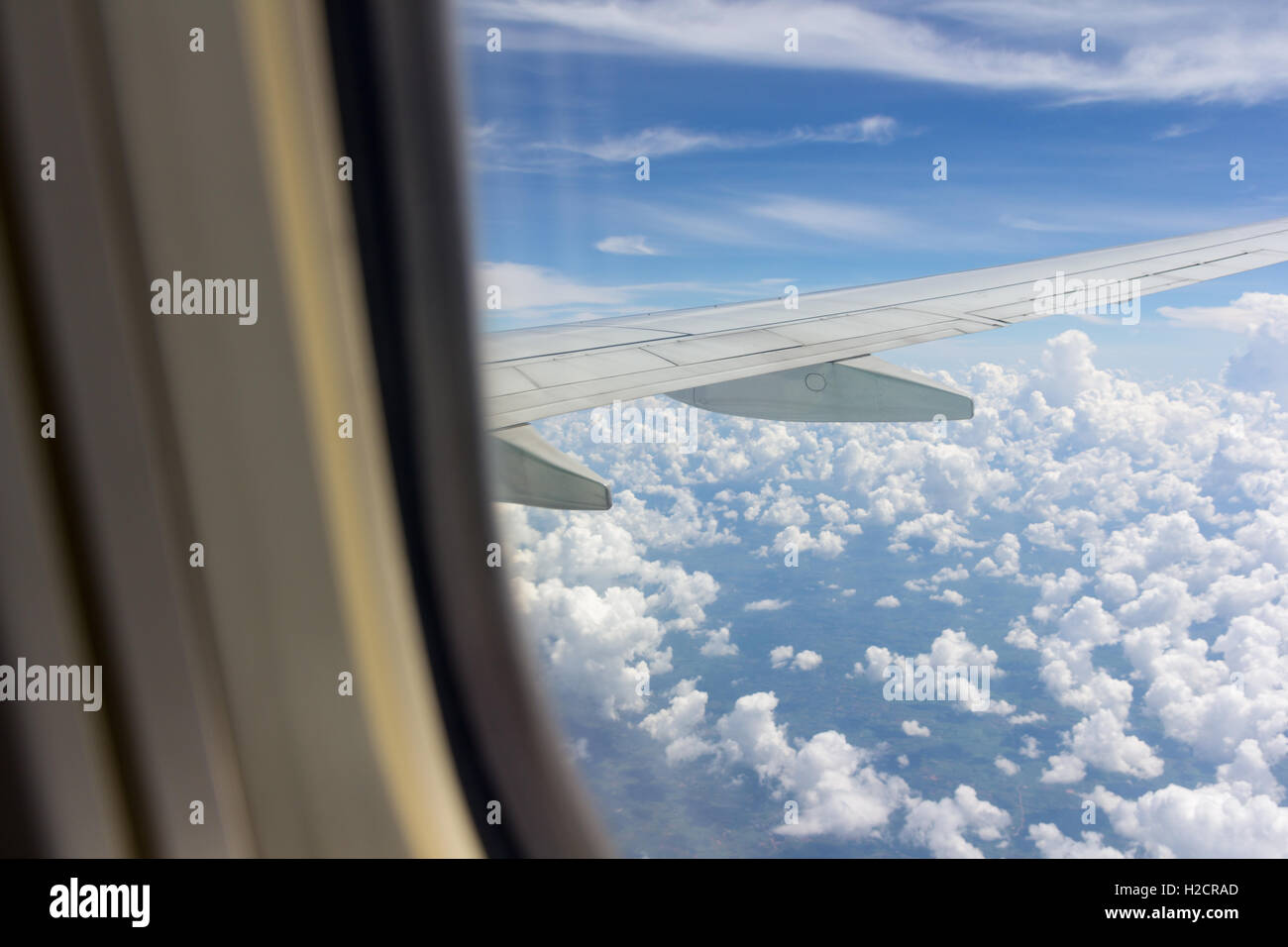 Wing of an airplane flying in the sky Stock Photo - Alamy