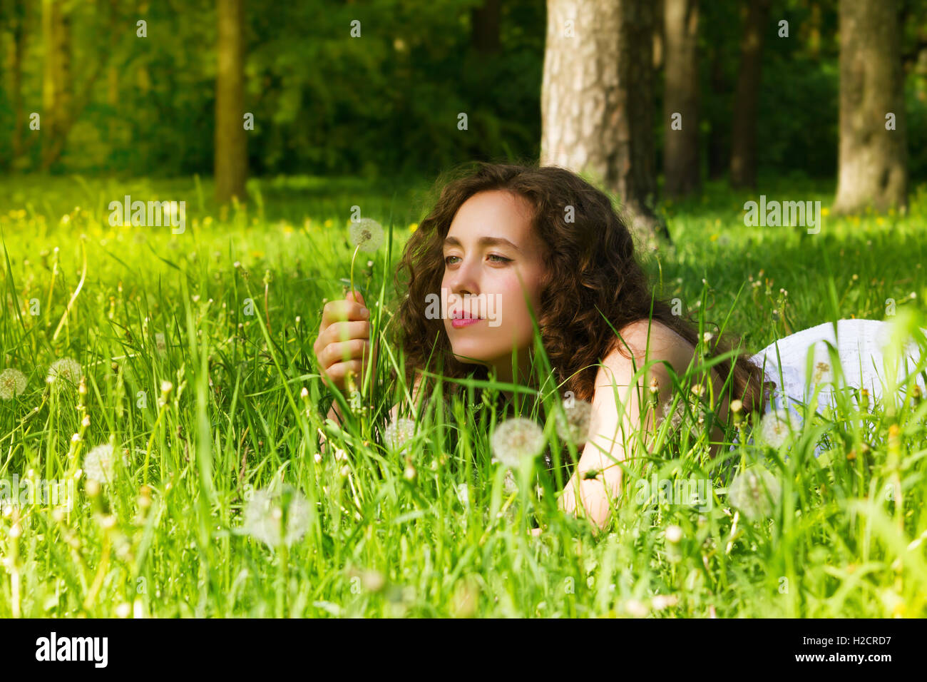 Woman having rest on a meadow Stock Photo - Alamy