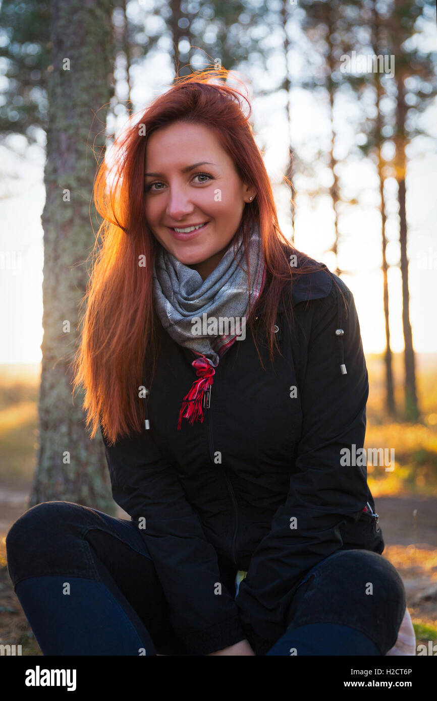 Woman in a sunset lights in an autumn forest Stock Photo - Alamy