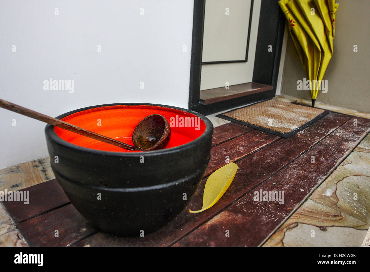 A water jar next to the door to a bungalow in a resort in Maldives ...
