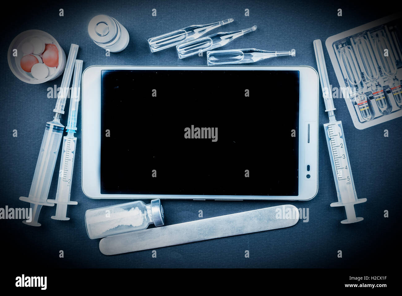 Tablet pc with medical objects on a desk Stock Photo - Alamy