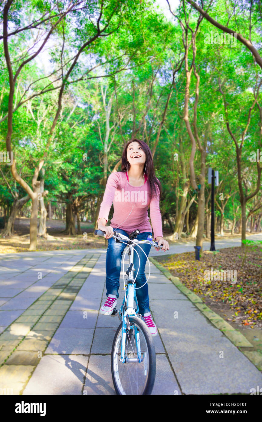 Pretty Woman riding a bike on the forest trail Stock Photo - Alamy