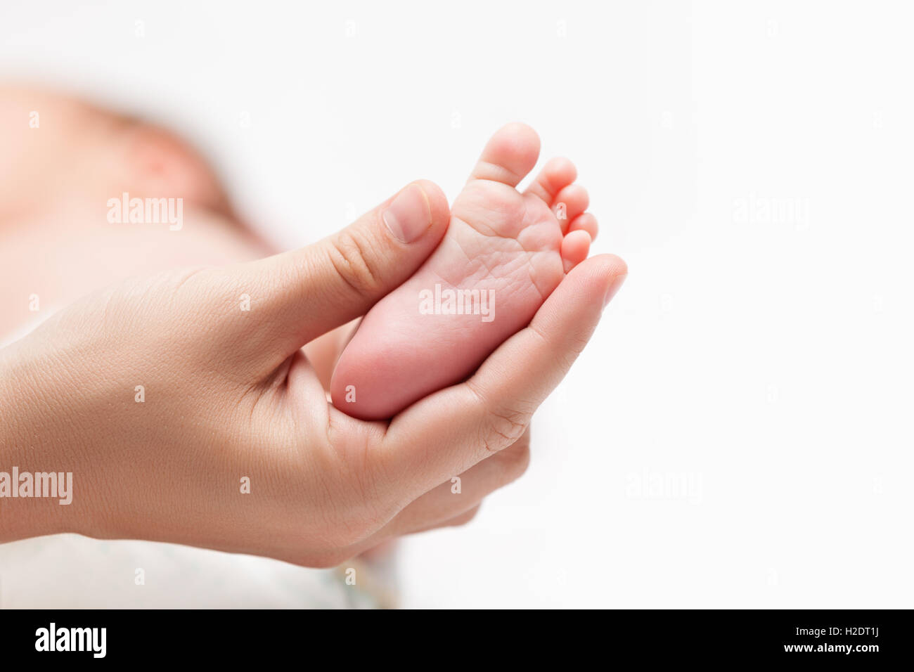 Newborn baby child little foot with heel and toes in mother hand Stock ...