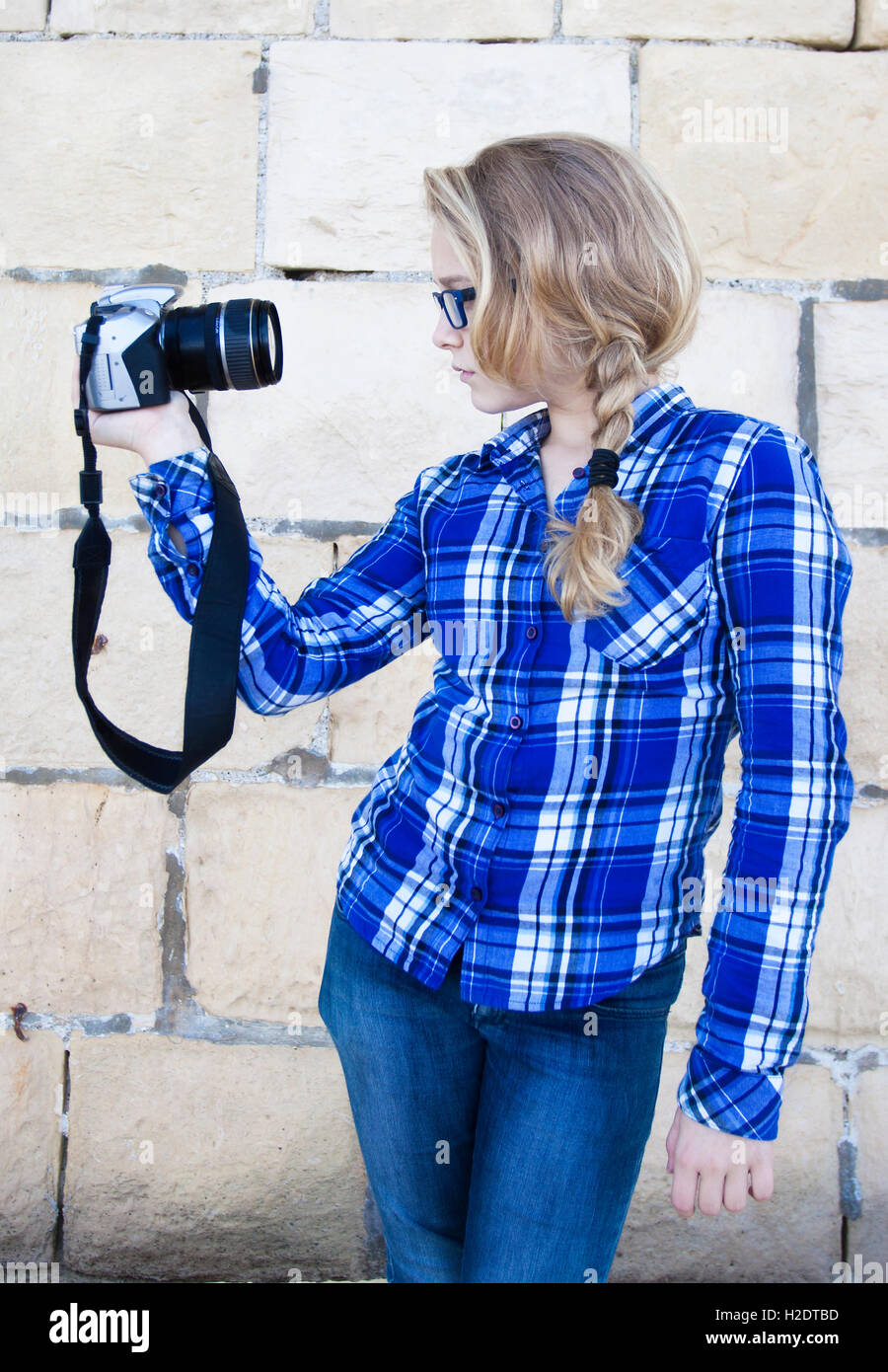 Cool kid holding a camera taking a photo of herself Stock Photo - Alamy