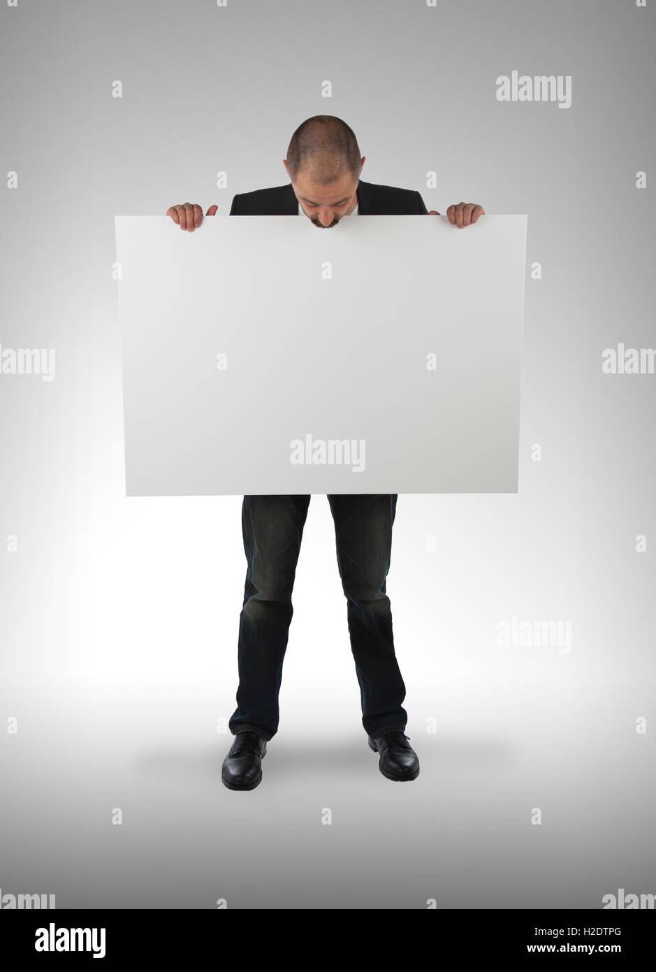 Businessman holding a big card Stock Photo - Alamy