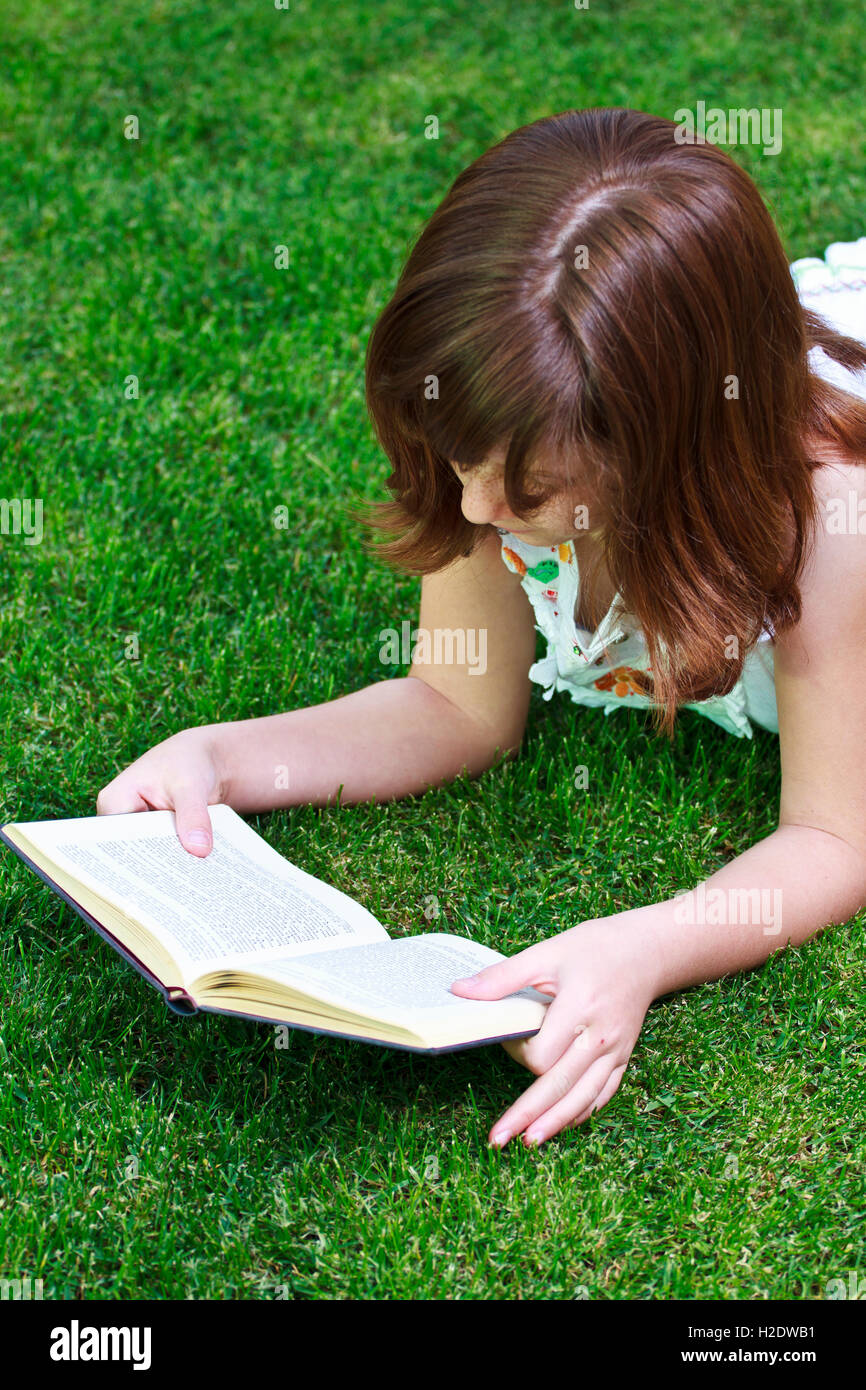 Idyllic.Young beautiful girl reading a book outdoor Stock Photo - Alamy