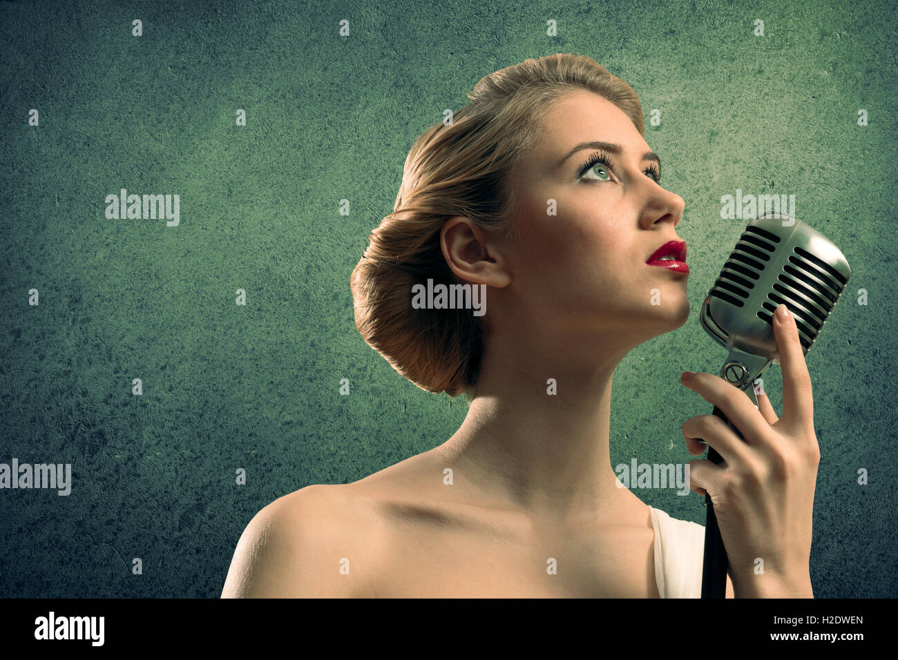 attractive female singer with microphone Stock Photo - Alamy