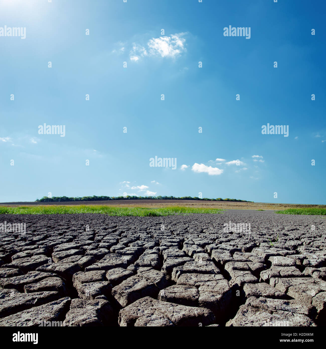hot sunlight in blue sky over drought earth Stock Photo - Alamy