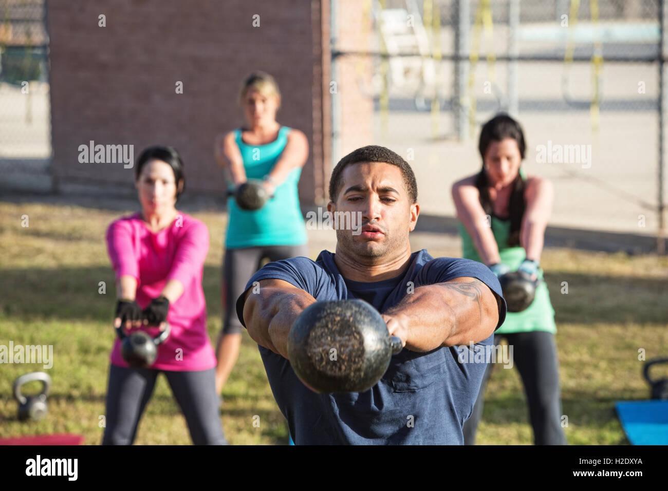 Four People Using Weights Stock Photo - Alamy
