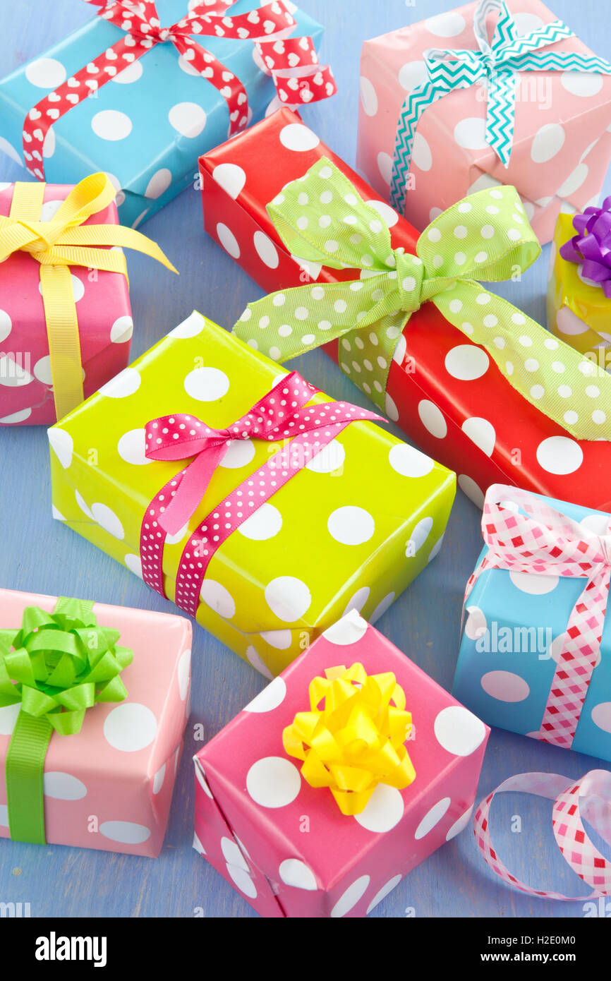 Colorful gift boxes wrapped in dotted paper Stock Photo - Alamy