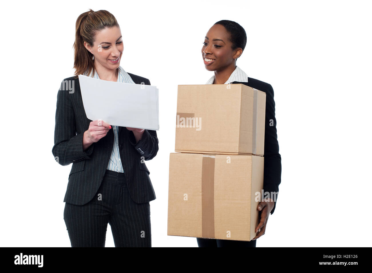 Two female workers discussing stock details Stock Photo - Alamy