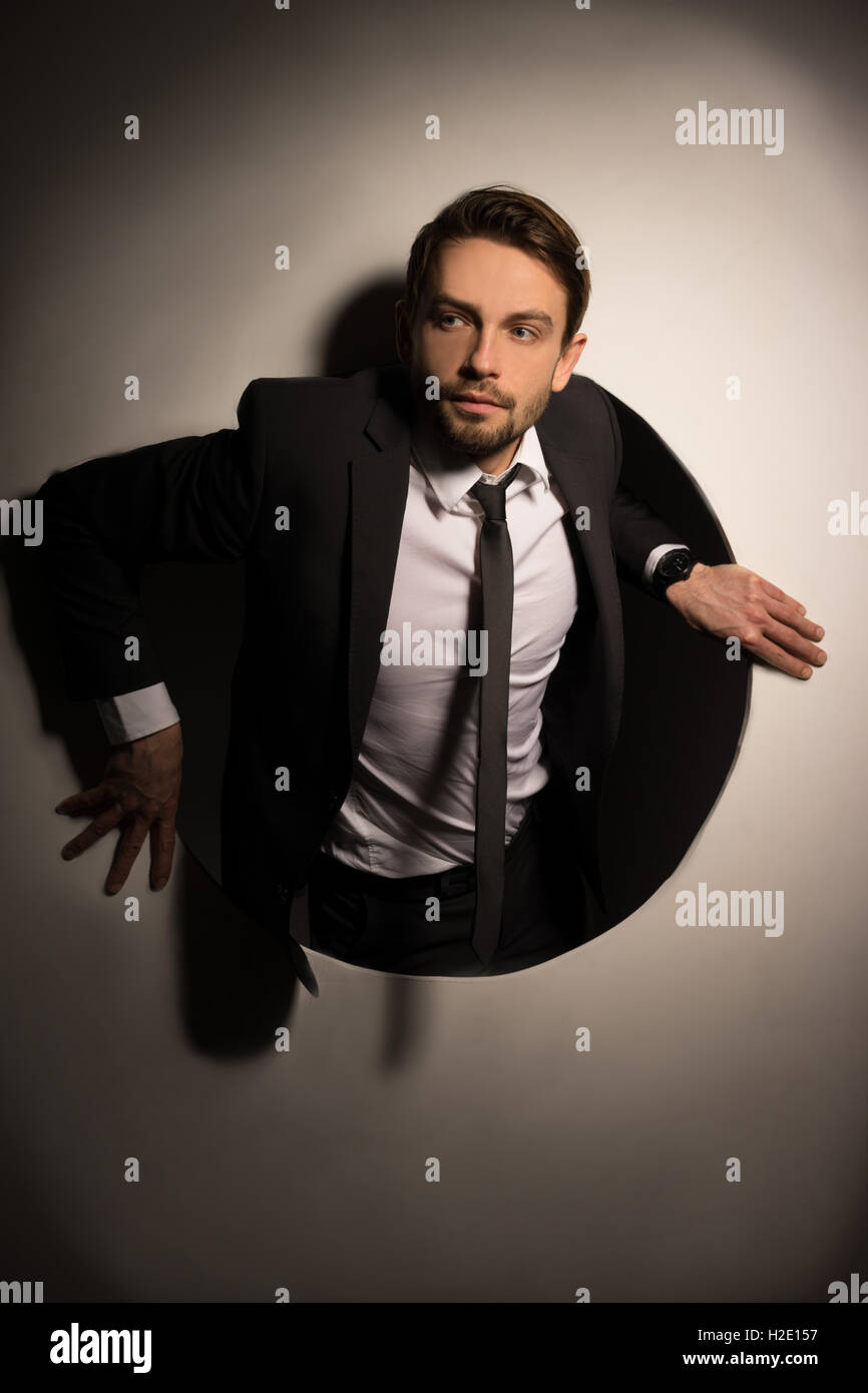 Man climbing out of hole hi-res stock photography and images - Alamy