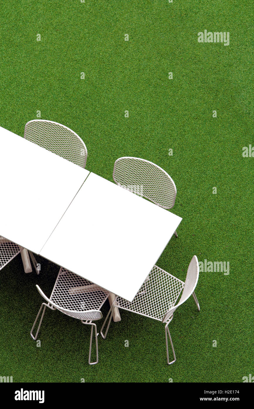 Chair and table on lawn at outdoor Stock Photo - Alamy