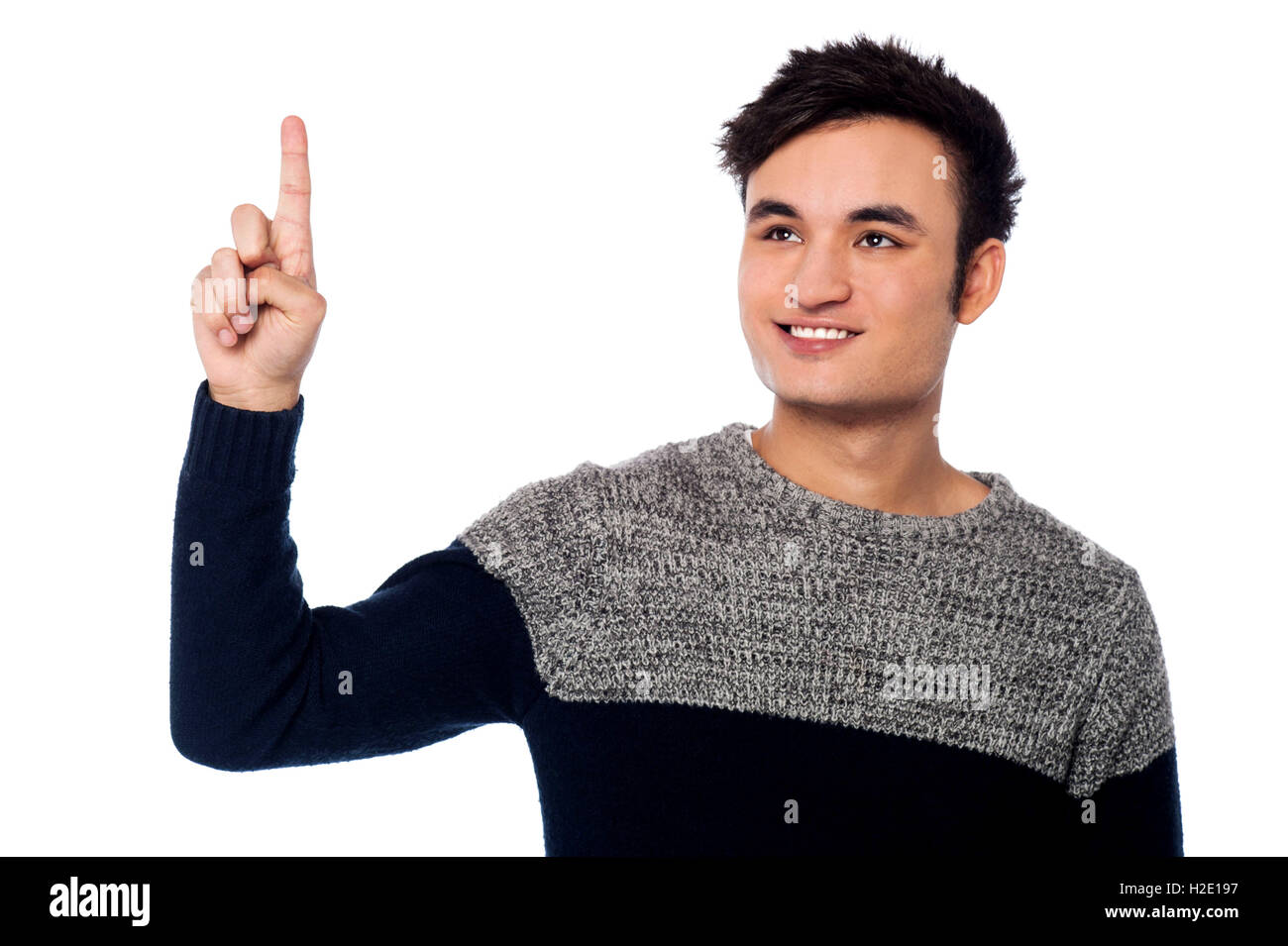 Young guy pointing upwards Stock Photo - Alamy