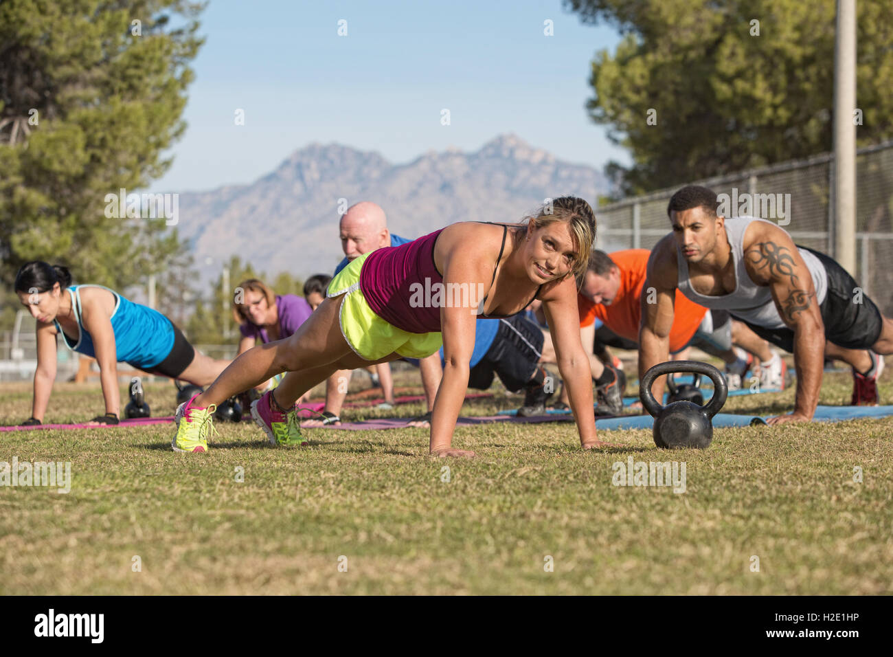 Group Doing Push-Ups with Instructor Stock Photo - Alamy