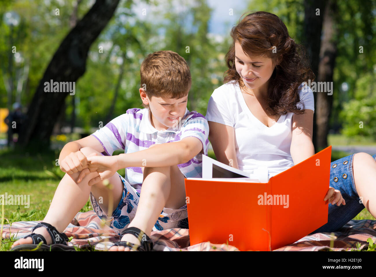 reading a book together Stock Photo - Alamy