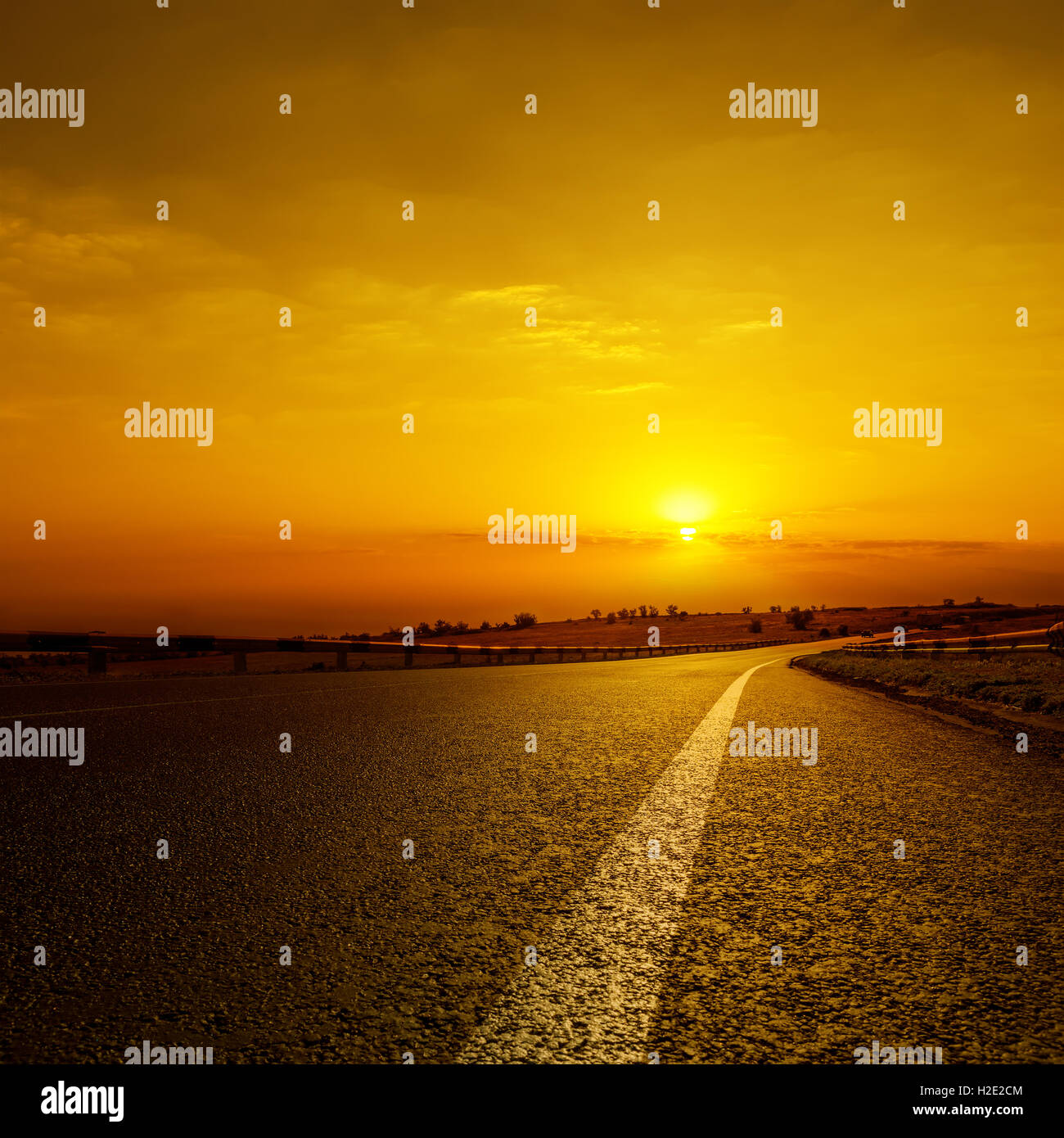 asphalt road to orange horizon in sunset Stock Photo - Alamy
