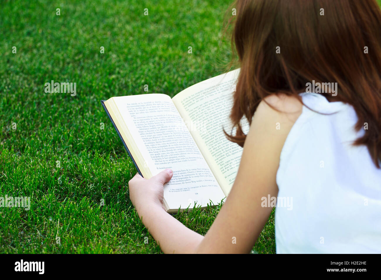 Student.Young beautiful girl reading a book outdoor Stock Photo - Alamy