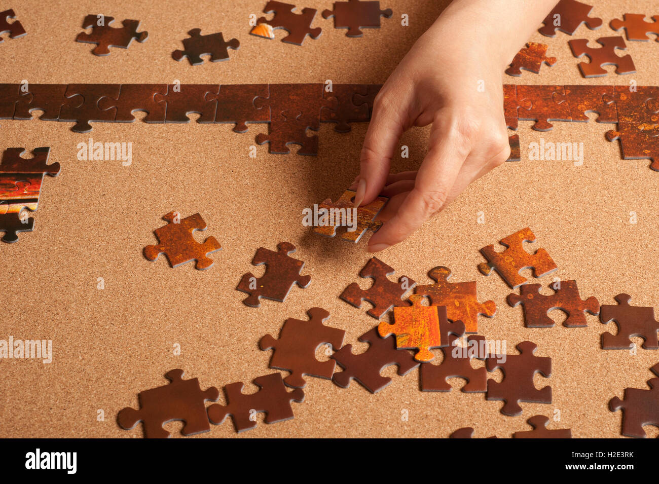 woman solving a jigsaw puzzle Stock Photo - Alamy