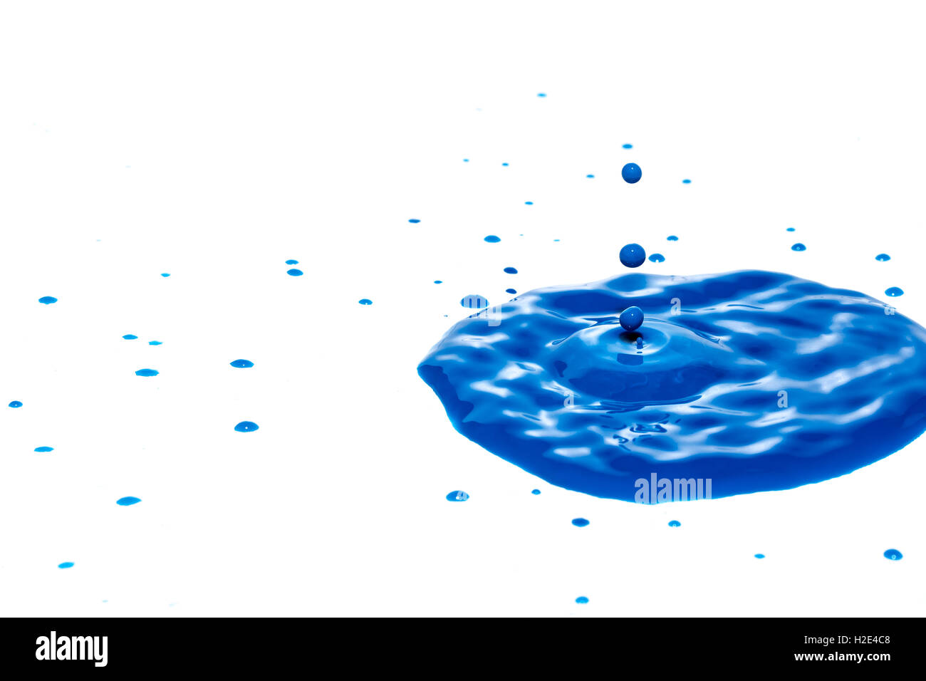 Closeup view of the three drop of blue color just before impact into a ...
