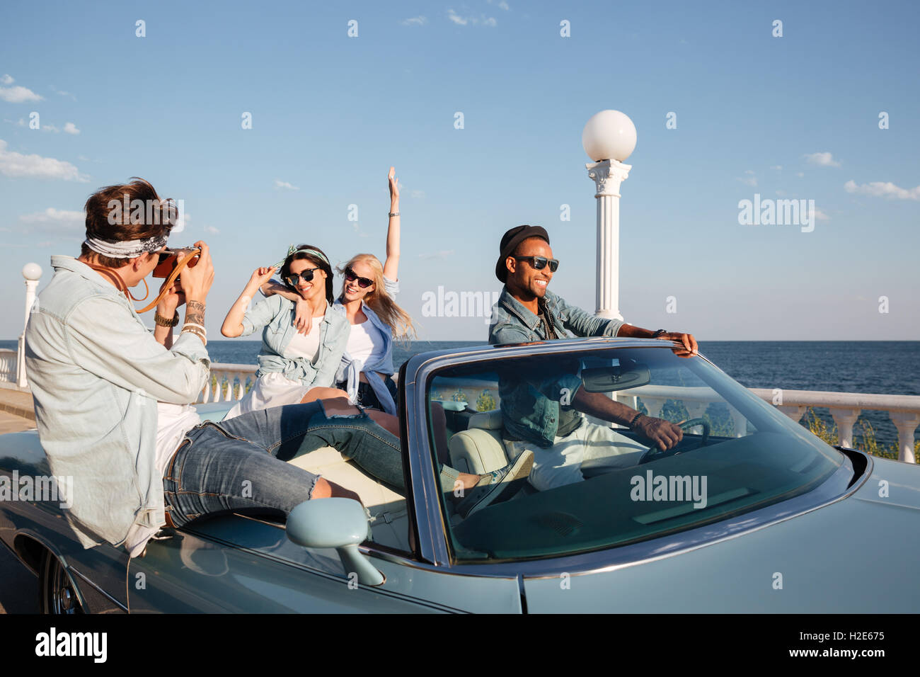 Group of cheerful young people driving a car and talking photos Stock ...