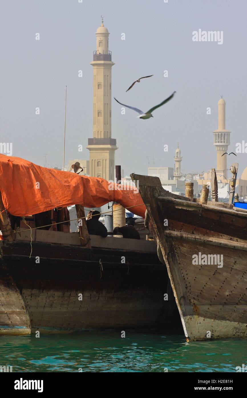 traditional arabic ships in front of the oldtown skyline of Dubai ...