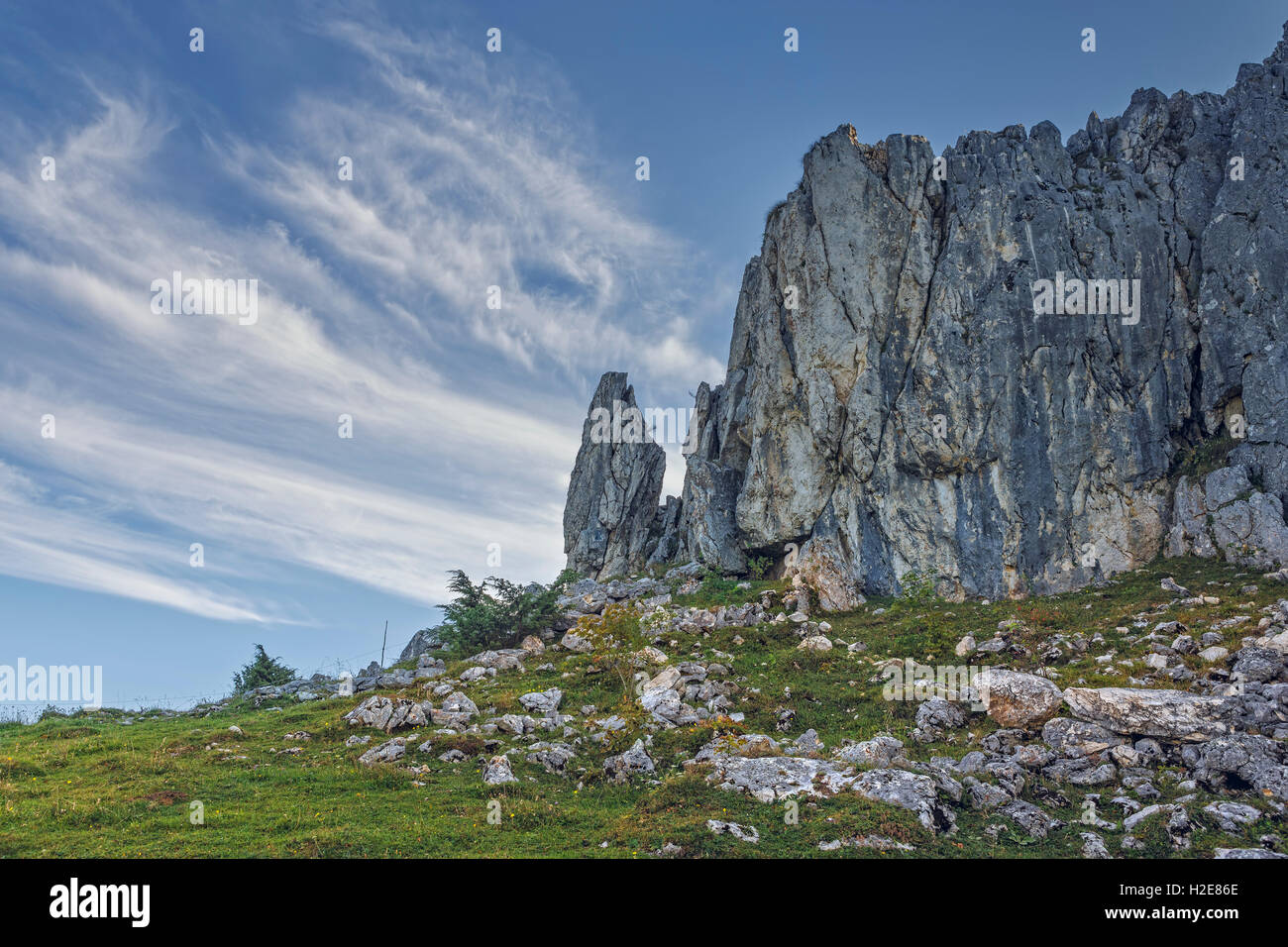 Alpine scenery with steep vertical rock cliff up in Magura Village ...