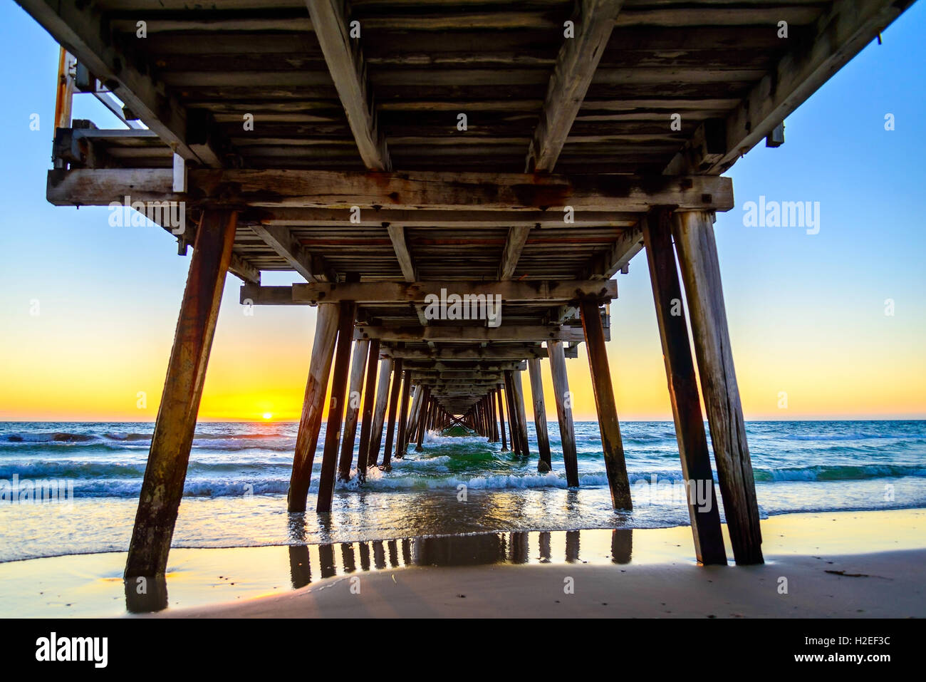 Sunset at Henley Beach viewed from under the jetty Stock Photo - Alamy