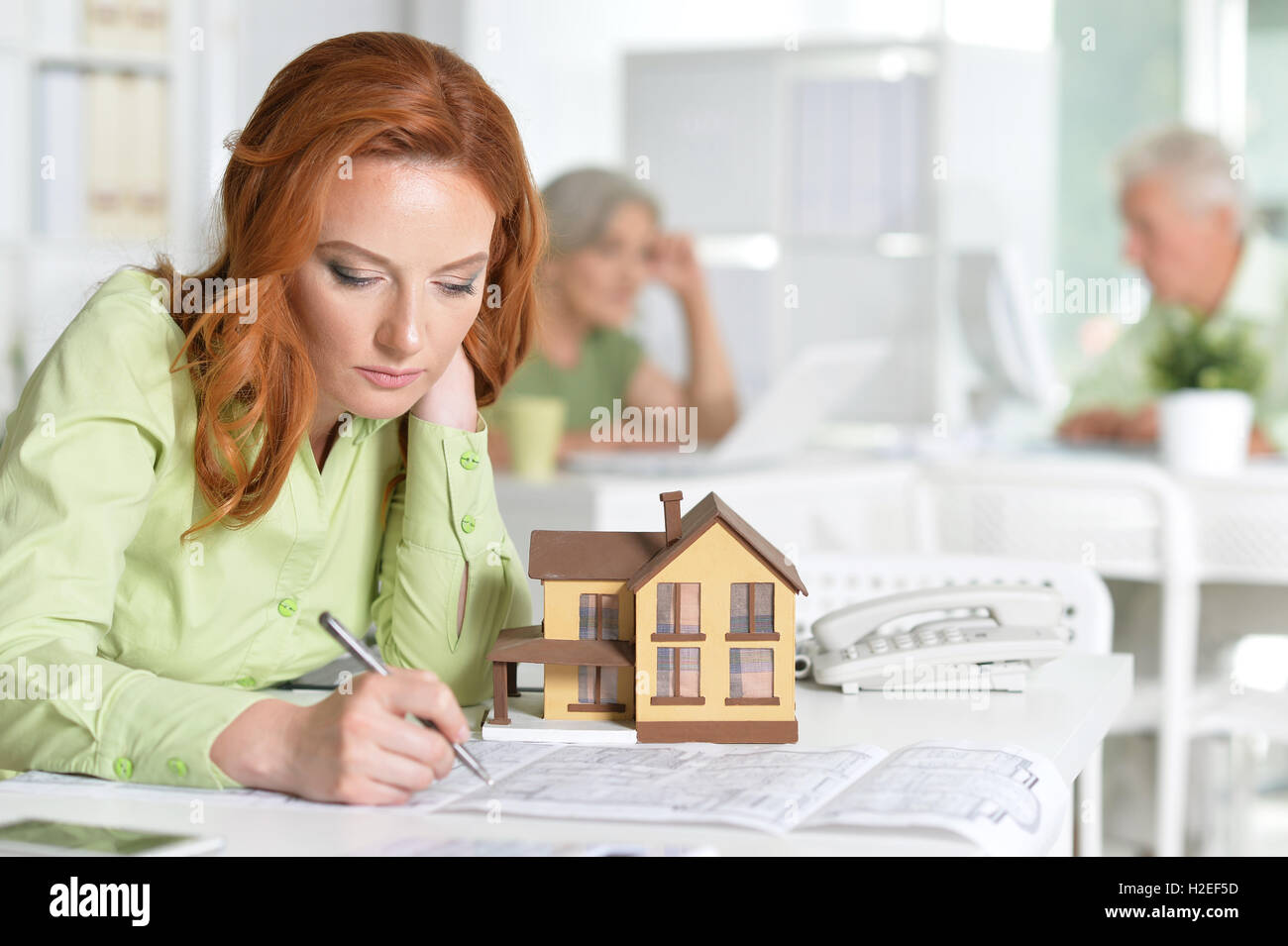 working Female house agent Stock Photo - Alamy
