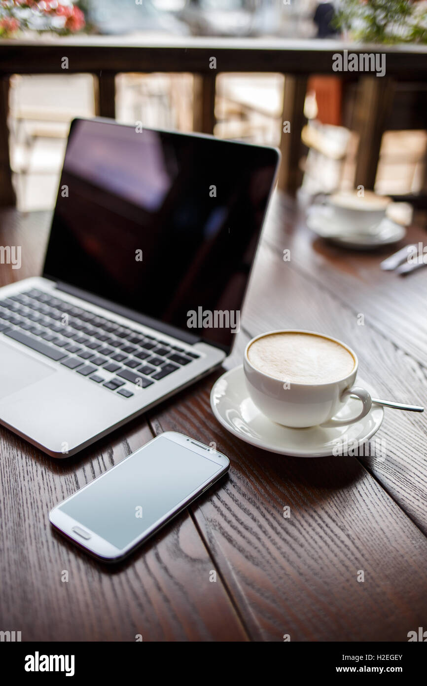 Mockup image with laptop, coffee and phone in cafe. Coffee break ...