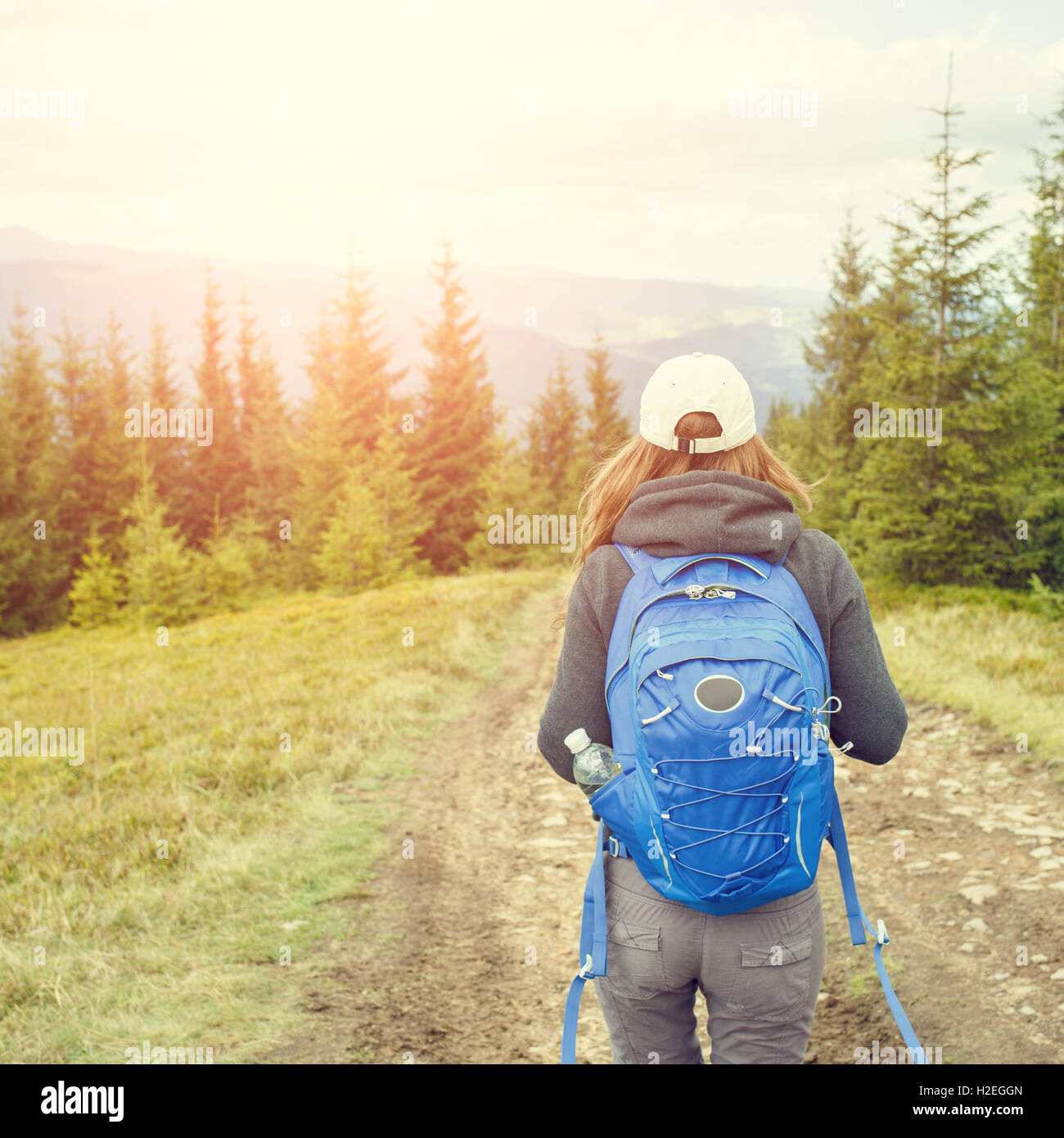 Young backpacker woman enjoying mountain trip. Pretty caucasian girl ...
