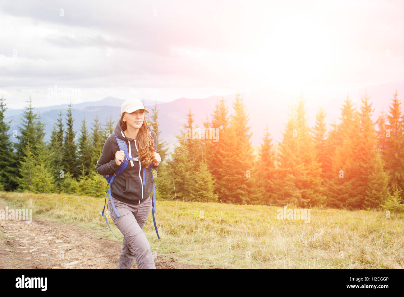 Young backpacker woman enjoying mountain trip. Pretty caucasian girl ...
