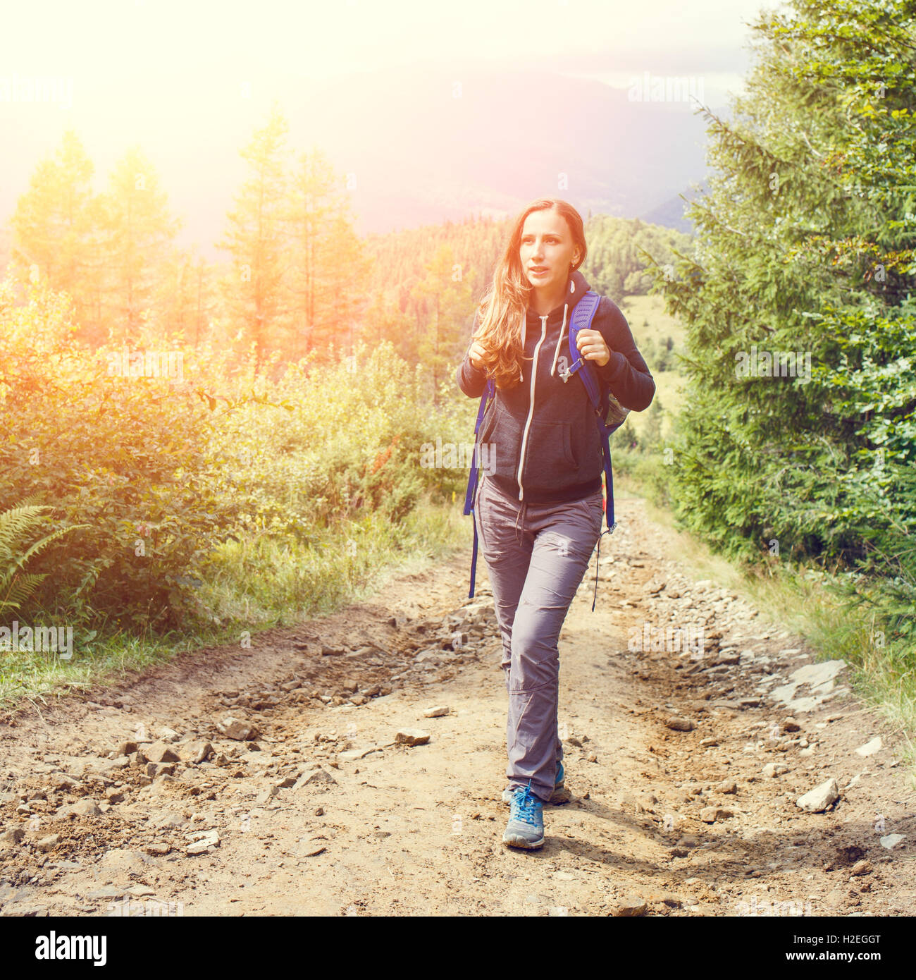 Young backpacker woman enjoying mountain trip. Pretty caucasian girl ...