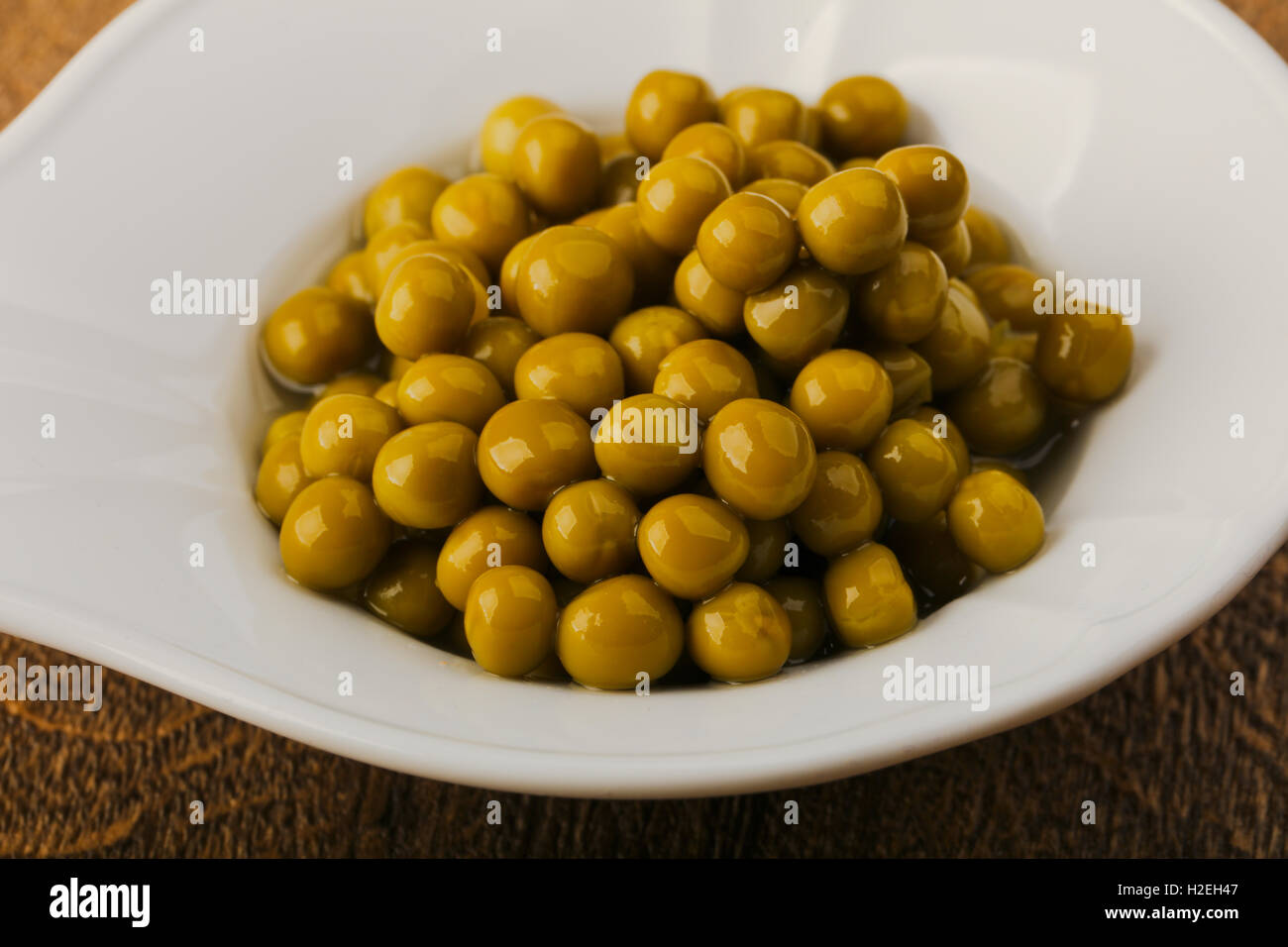 Pickled green pea on the wood background Stock Photo - Alamy