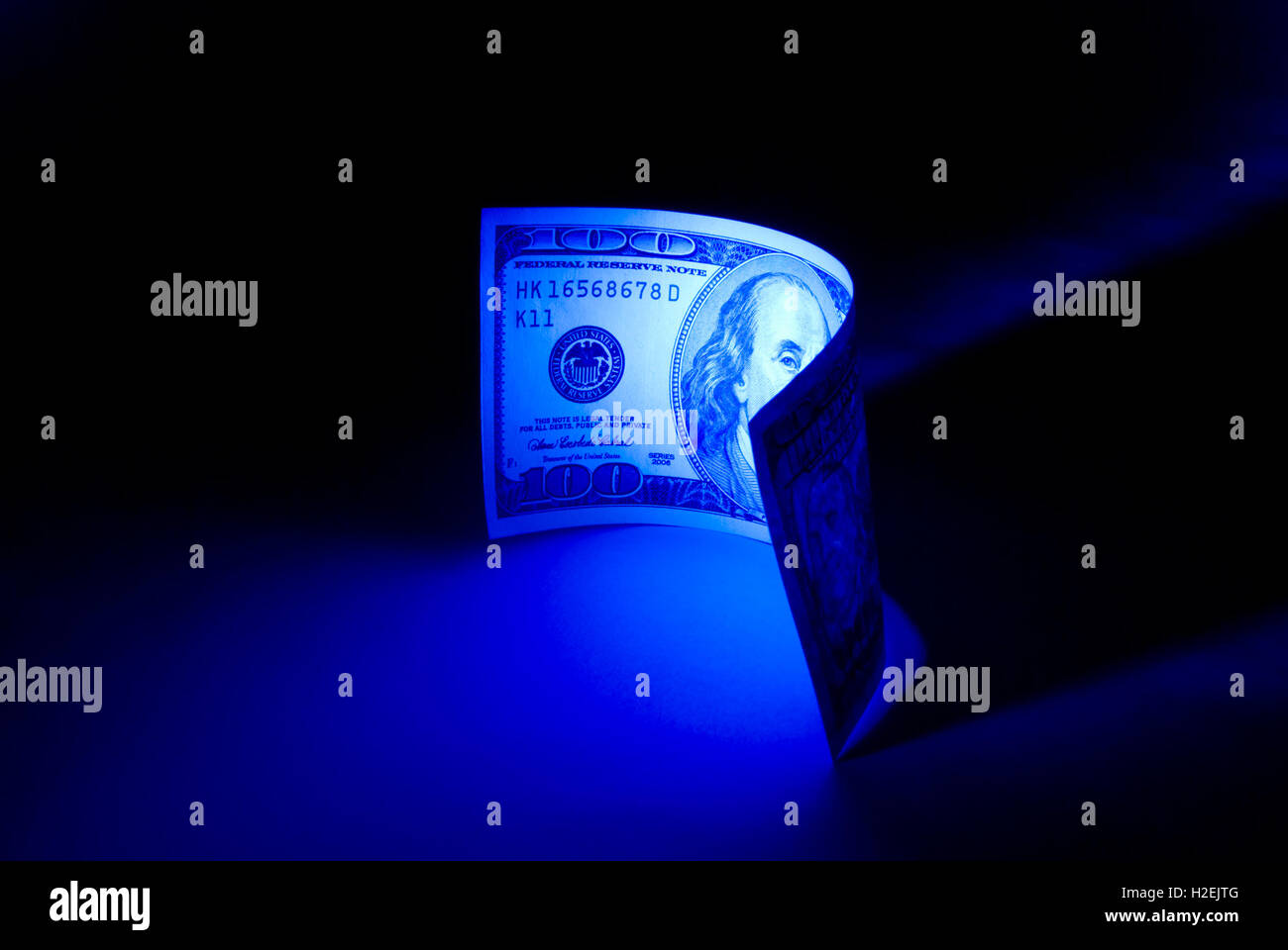 Hundred dollars. Beautiful art illumination. A dark blue background ...