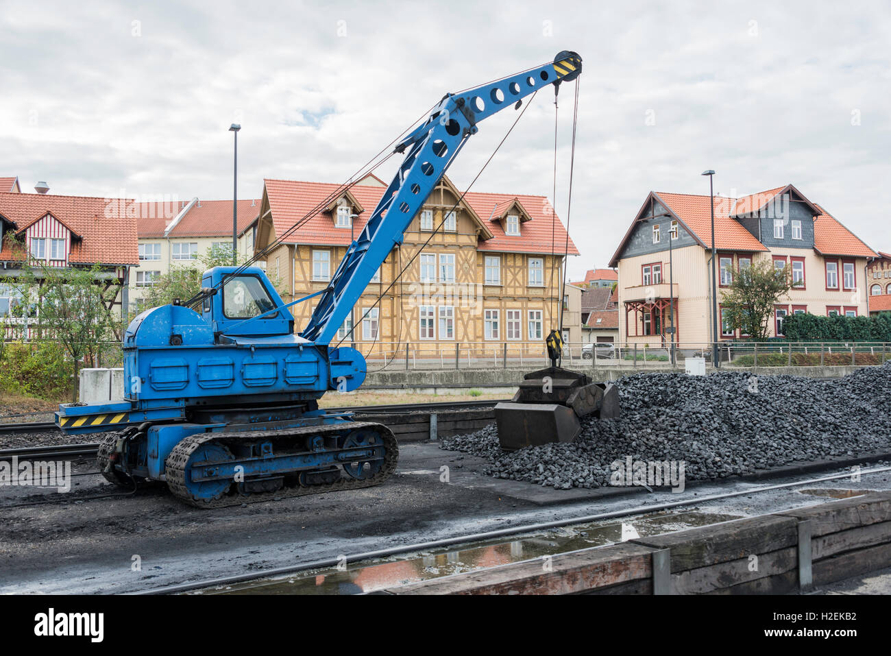 old blue crane with crawler with bucket to load coal into the steam ...