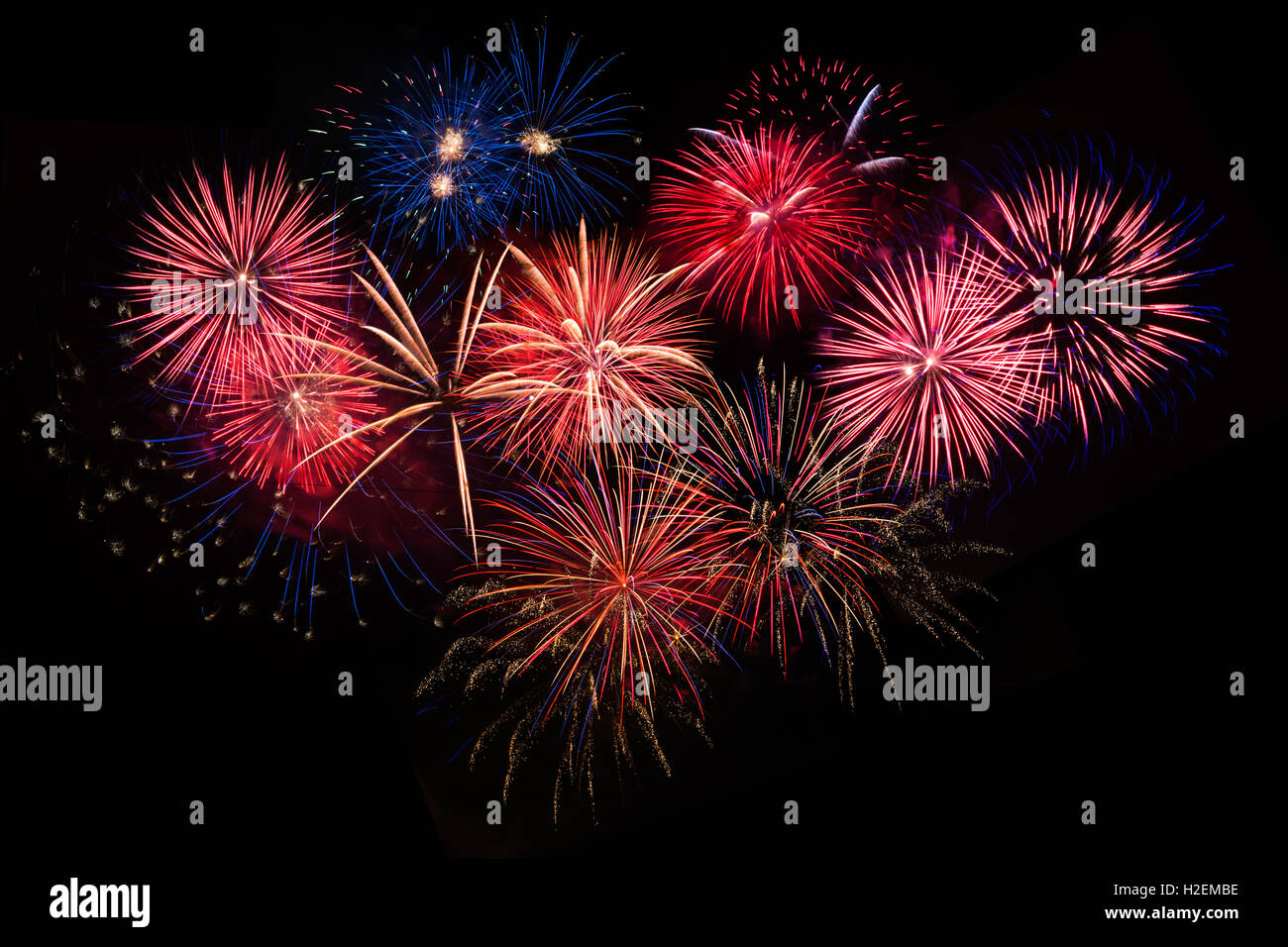 Red, golden, blue fireworks over night sky. Celebration beautiful ...