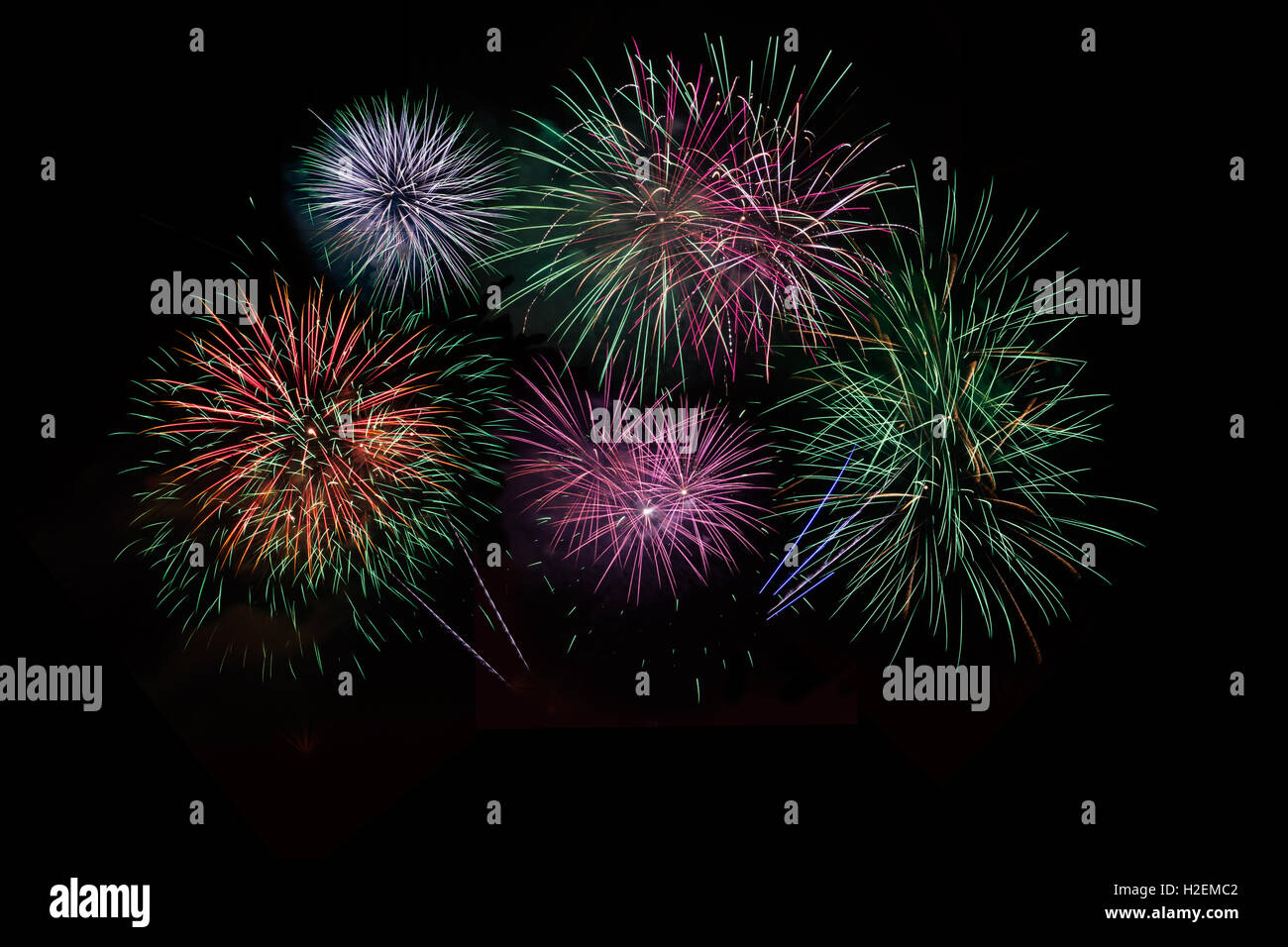 Red, green, purple, lilac fireworks over night sky. Celebration ...