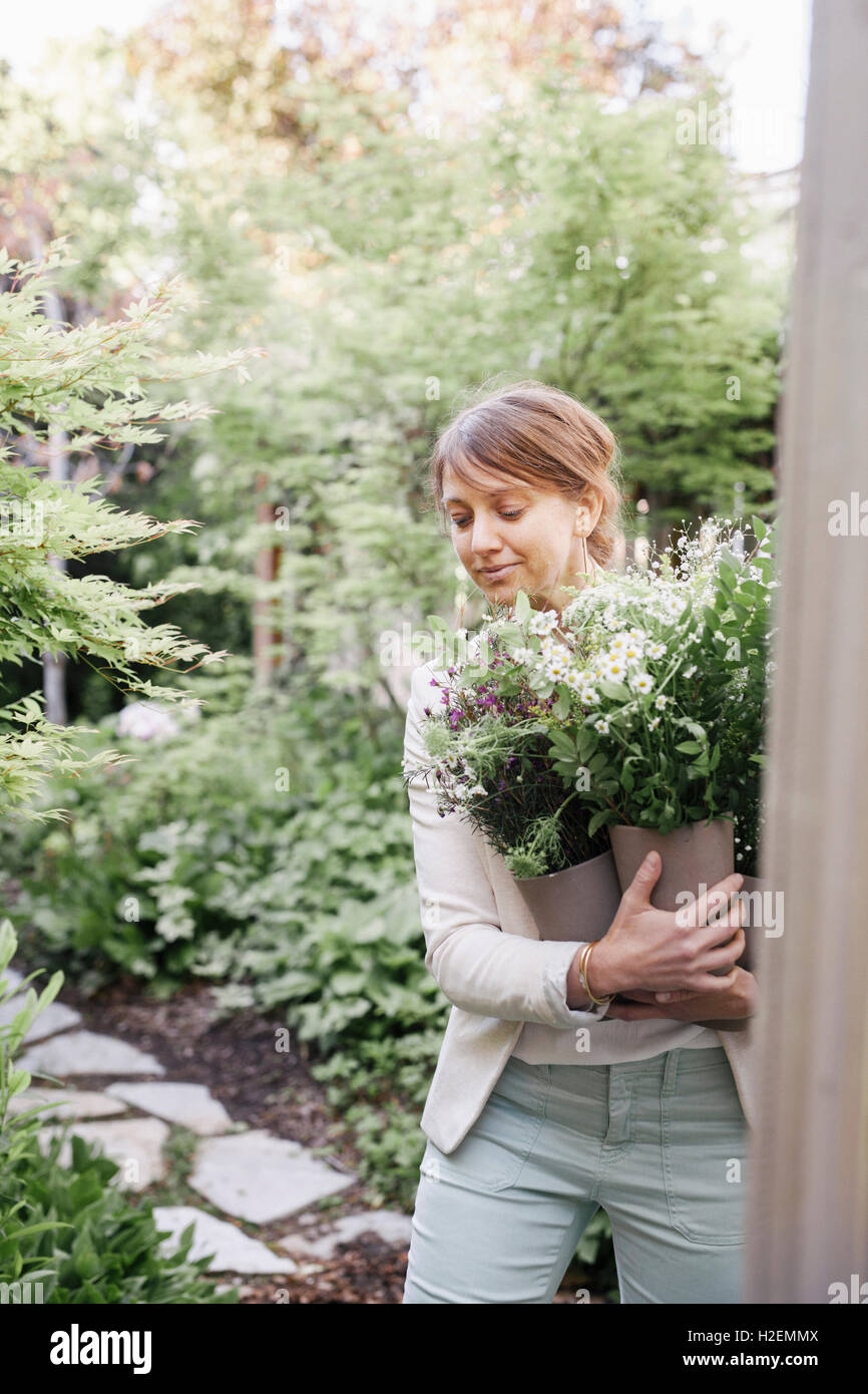 Woman walking garden flowers hi-res stock photography and images - Alamy