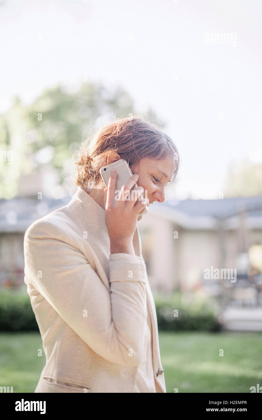 Woman talking into a phone hi-res stock photography and images - Alamy