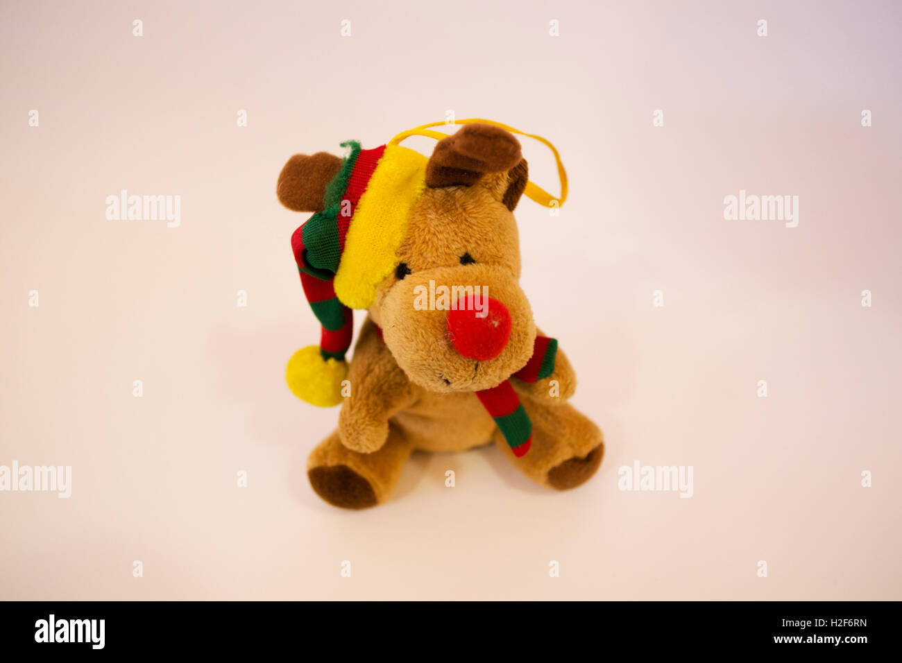 image of toy dog doll with colorful cap and scarf brown in color in ...