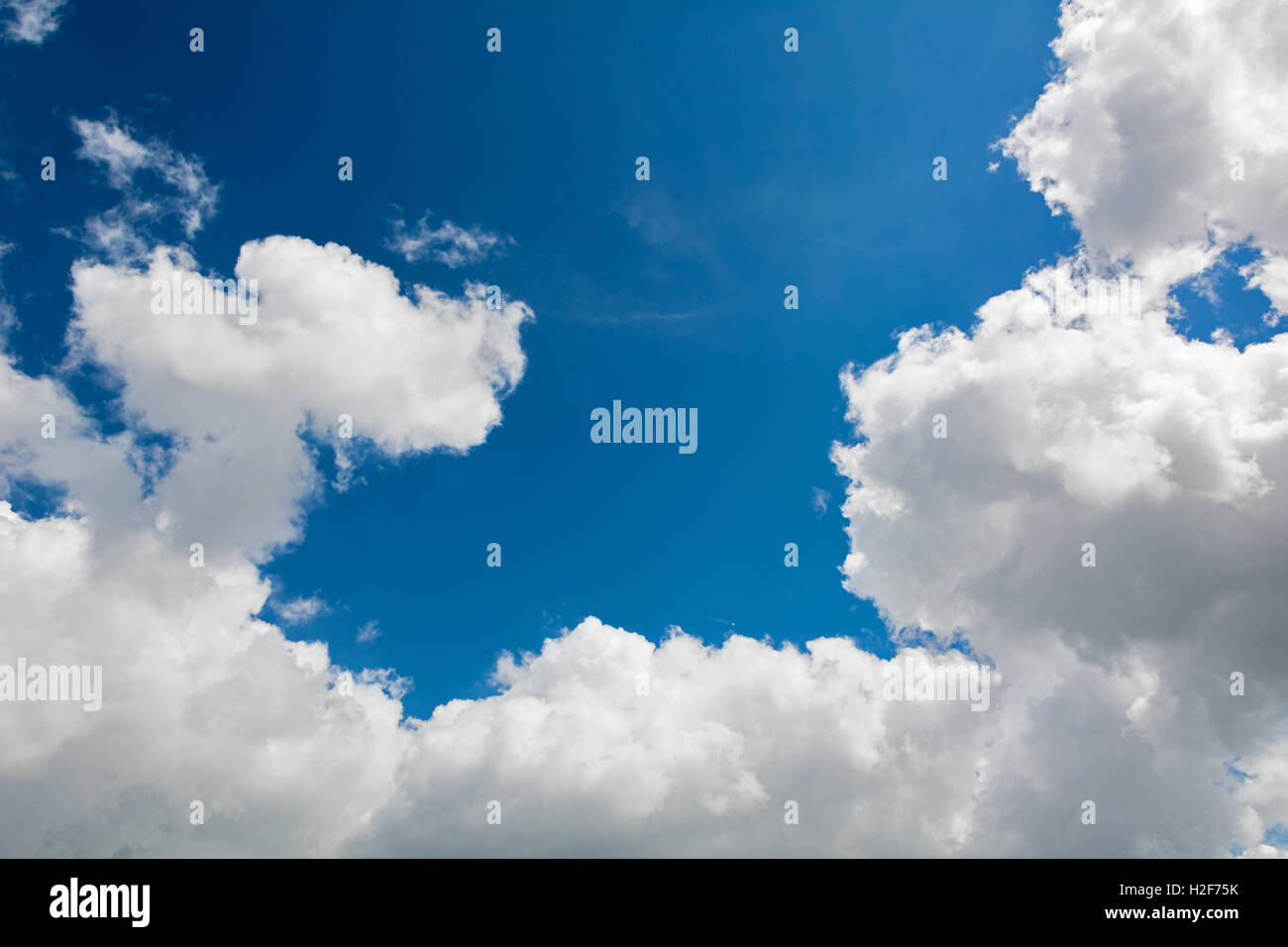 raised clouds on a blue sky Stock Photo - Alamy