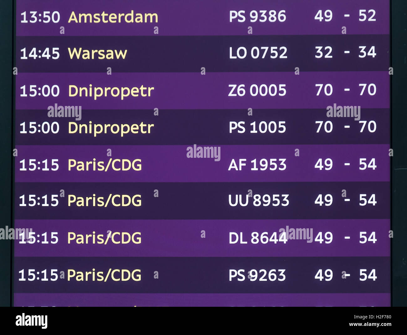 International arrivals board panel Stock Photo - Alamy