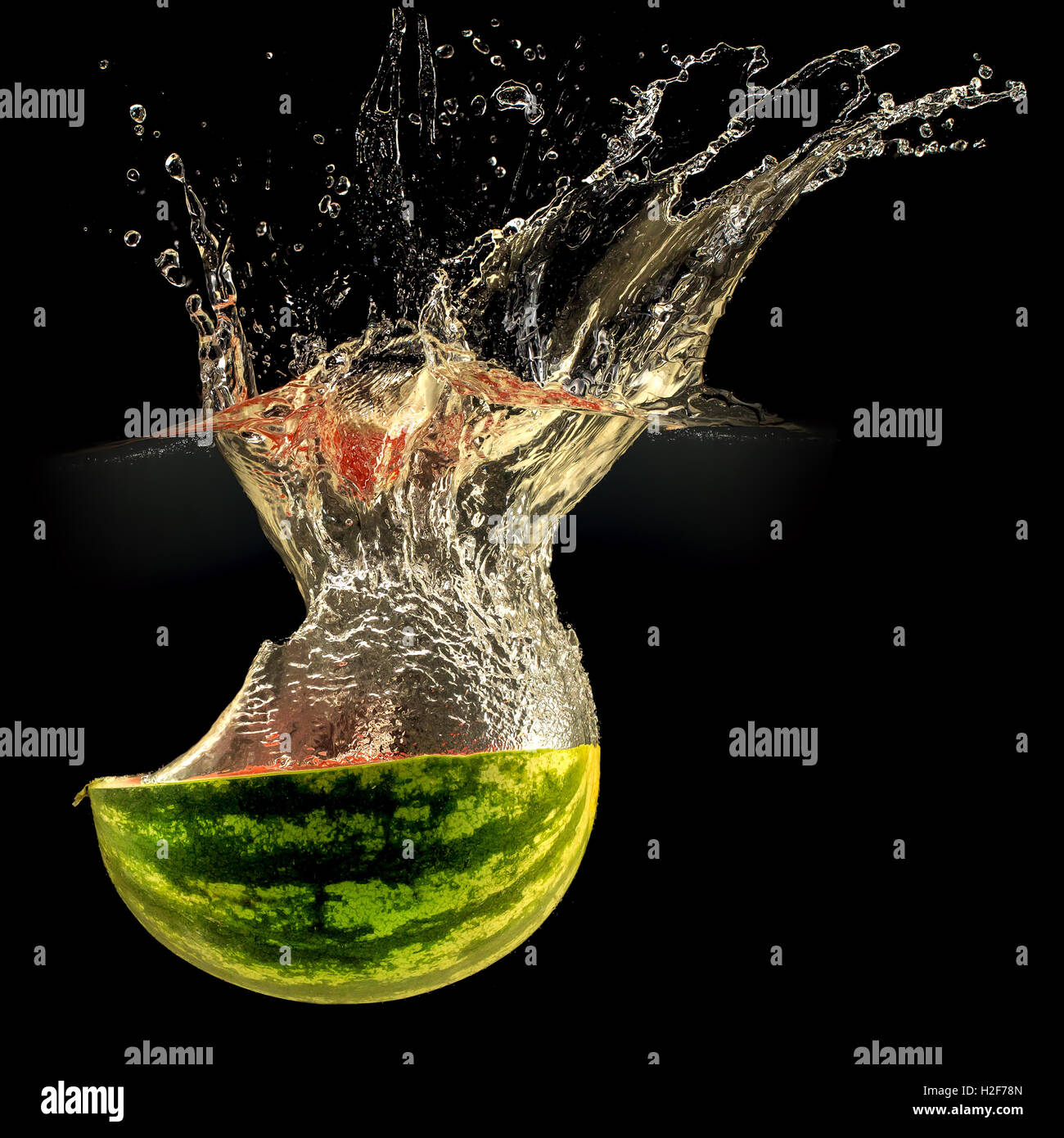 Fresh melon falling in water with splash on black background Stock ...